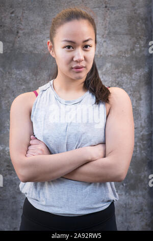 Young Asian women stretching arms wearing headphones relaxing during ...
