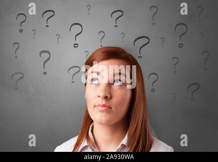 Person with question marks around face Stock Photo - Alamy