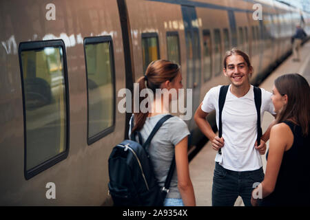 Friends on train station Stock Photo - Alamy