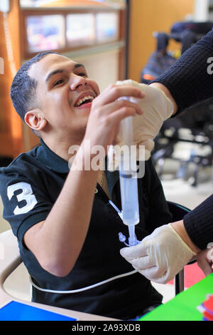 Boy with Spastic Quadriplegic Cerebral Palsy using using his helmet and ...