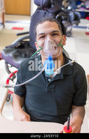 Boy with Spastic Quadriplegic Cerebral Palsy using using his helmet and ...