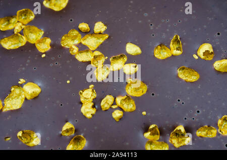 Real Gold flakes seen on the chocolate layered desert. Eatable gold ...