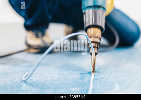 How to heat welding vinyl floor with heat gun - hot air gun Stock Photo ...