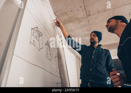 Two young thiefs are sitting in a room and planning a heist Stock Photo ...