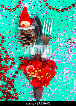 Festive table cutlery with snowman, cone, colorful confetti, and red ...