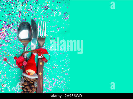 Festive table cutlery with snowman, cone, colorful confetti, and red ...