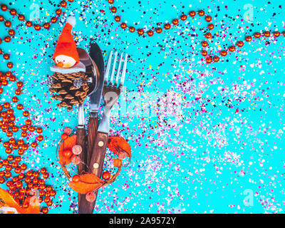 Festive table cutlery with snowman, cone, colorful confetti, and red ...