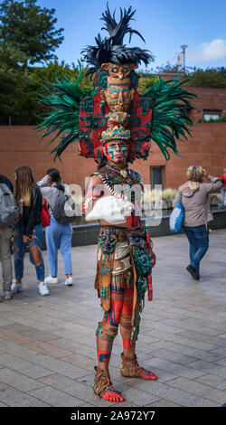 Aztec indian man in traditional dress playing the madolin during a ...