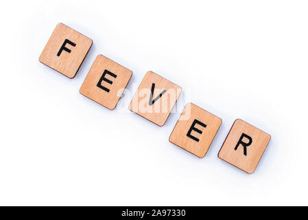 The word FEVER, spelt with wooden letter tiles over a white background ...