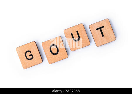The word GOUT, spelt with wooden letter tiles over a white background ...