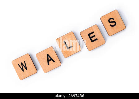 The word WALES, spelt with wooden letter tiles, over a plain white ...