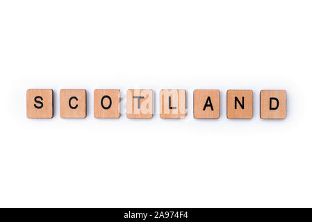 The word SCOTLAND, spelt with wooden letter tiles, over a plain white ...