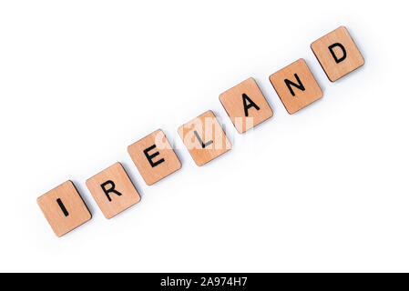 The word IRELAND, spelt with wooden letter tiles, over a plain white ...