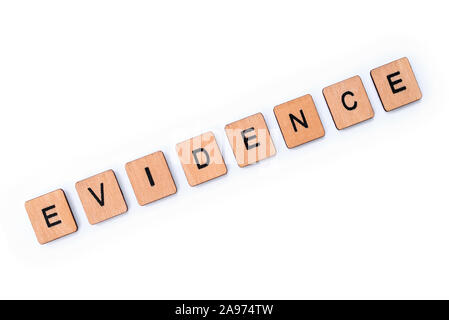 The word EVIDENCE, spelt with wooden letter tiles over a plain white ...