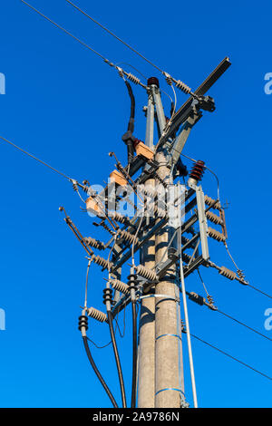 Medium voltage disconnectors on electricity pylon. Power line pole with ...