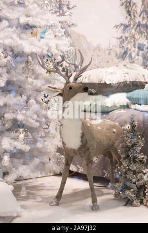 Interior of light bedroom with Christmas tree and glowing lights Stock ...