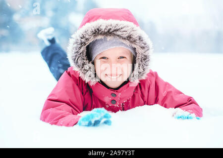 Pink light falling on smiling businessman using desktop PC at desk in ...
