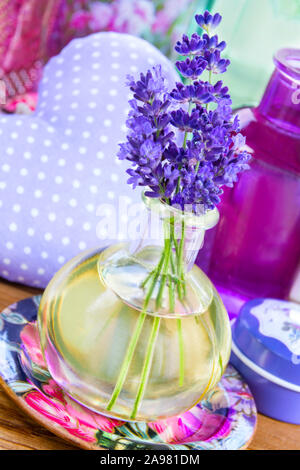 Purple lavender flowers with glass flask, vial and test tubes in ...