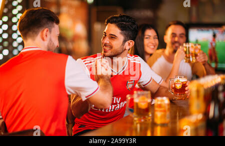 Party excited arsenal fans watching soccer with Ganzberg Beer in the ...