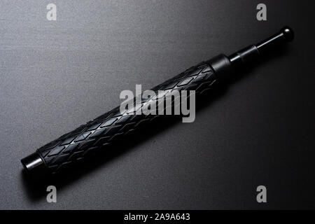 Black telescopic expandable baton / truncheon isolated Stock Photo - Alamy