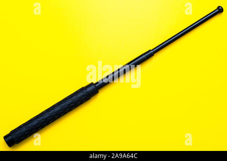 Black telescopic expandable baton / truncheon isolated Stock Photo - Alamy