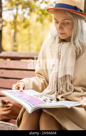 Mature woman learning foreign language Stock Photo - Alamy