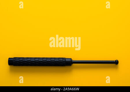 Black telescopic expandable baton / truncheon isolated Stock Photo - Alamy