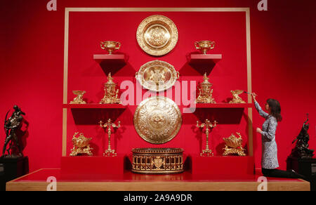 A Royal Collection staff member dusts the frame of Landscape with Saint ...
