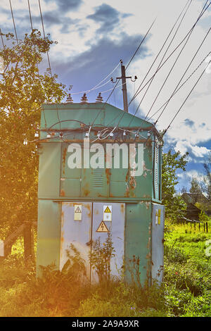 Green transformer box, with a danger sign on a sunny day Stock Photo ...