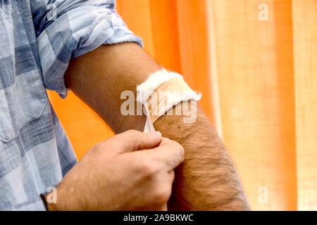 stopping the bleeding after veni, image puncture Stock Photo - Alamy