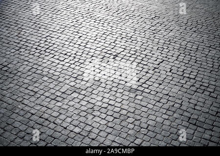 Cobblestone arched pavement road with red, brown, yellow and gray rocks ...