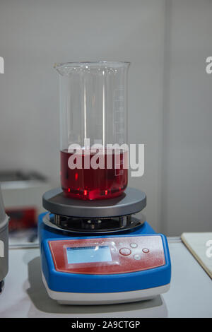 Digital lab scale with chemical flask. 3D rendering isolated on white ...