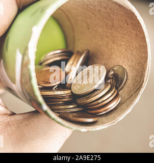 Currency, money, man holding coins, india Stock Photo - Alamy