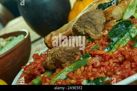 West African national cuisine. Jollof rice with grilled chicken wings ...