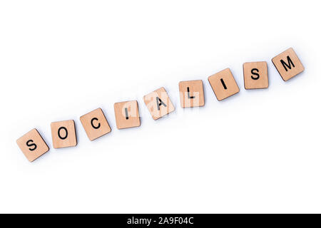 The word SOCIALISM, spelt with wooden letter tiles over a plain white ...
