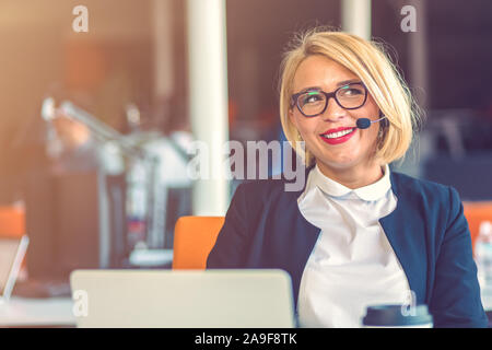 Customer service representative at work. Beautiful young woman in ...