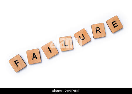 The word FAILURE, spelt with wooden letter tiles over a white ...