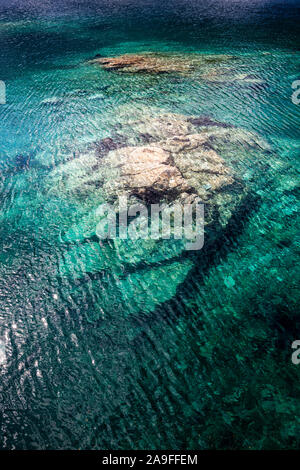 Limpid sea water surface with stones on bottom. View from above. Nature ...