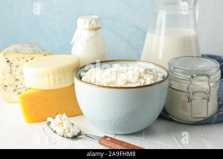 dairy products on table against the background of herd of cows in barn ...