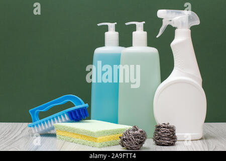 Three blastic bottles of dishwashing liquid, glass and tile cleaner ...