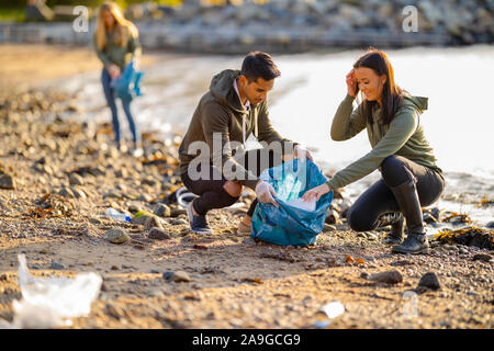 Multi-generation volunteer people collecting garbage Stock Photo - Alamy