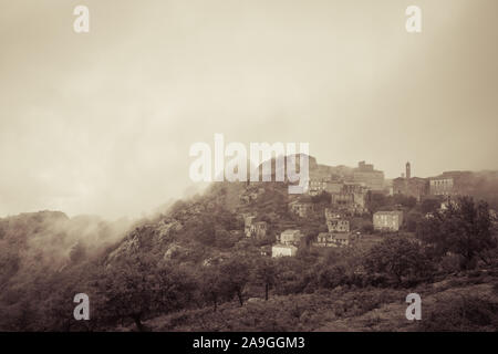 Sepia image of the ancient mountain village of Speloncato shrouded in ...