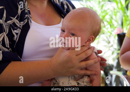 Baby being winded by her mother Stock Photo - Alamy
