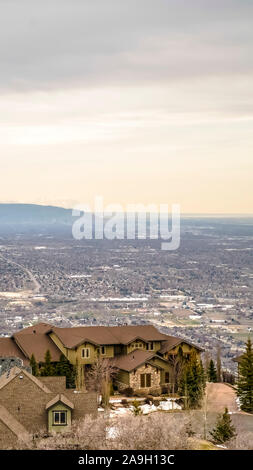 Vertical frame Rooftops of homes with cloudy sky mountain and vast ...