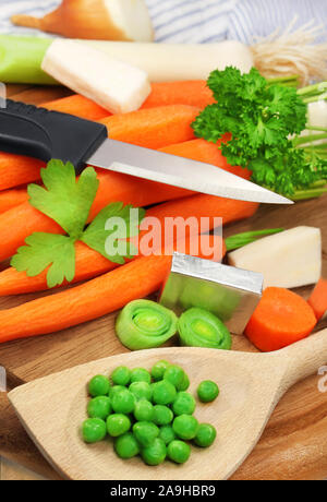 Wooden spoon and knife with ingredients on dark background. Top view ...