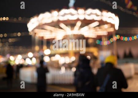 Carousel with burning lights in evening, defocused photo Stock Photo ...