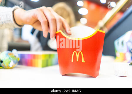 Mc Donald empty french fries container box left on the pavement of the ...