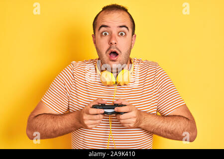 Portrait of nervous gamer guy playing video games on computer wearing ...