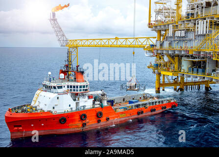 Shipping box is loaded from an offshore rig to the supply vessel Stock ...