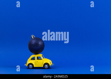 Vilnius, Lithuania - November 15, 2019: Yellow retro toy model car with ...